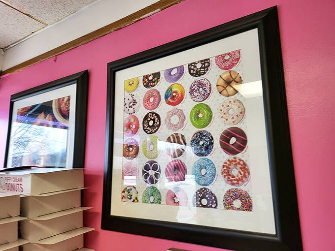 A gallery of donut dreams adorns the pink wall, like a vision board for your breakfast aspirations.