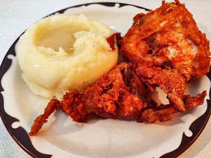 The holy trinity of comfort food: crispy chicken, pillowy mashed potatoes, and gravy that could make a vegetarian question their life choices.