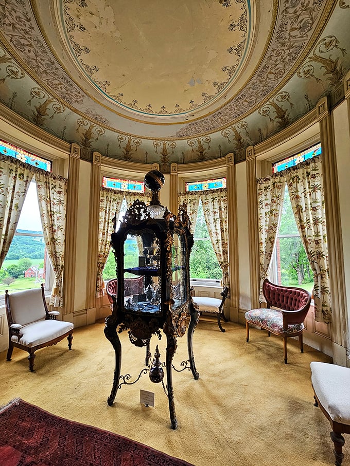 The curved windows and period furniture create a room where you half expect a Victorian ghost to offer you tea and gossip about the neighbors.