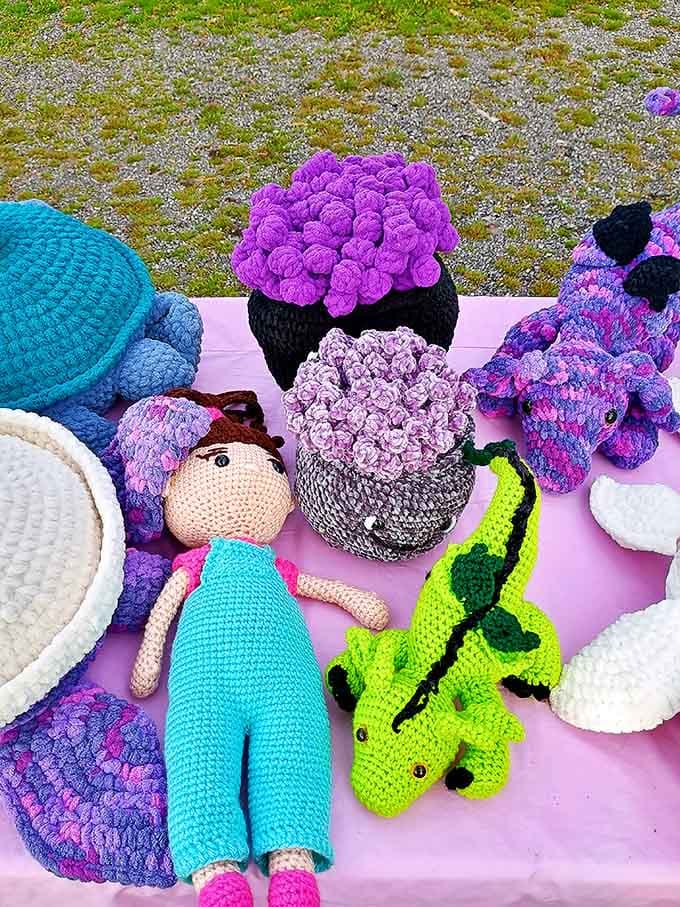 Handcrafted crochet creatures form a rainbow of textile art, each stitch representing hours of patient work by skilled local artisans.