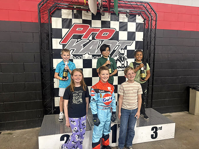 Young champions beam with pride on the winner's podium. Today's go-kart racers, tomorrow's NASCAR stars!