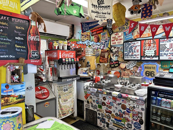 Behind the counter, decades of memorabilia create a living museum where every sticker, photo, and sign tells part of the Snow Cap story.
