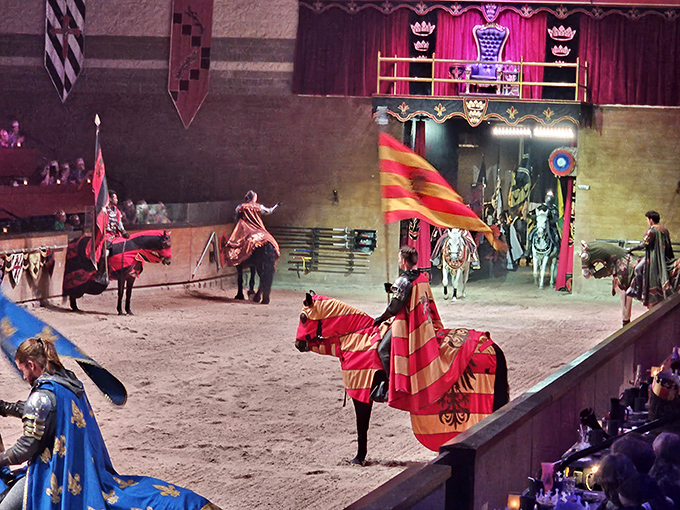 Knights on horseback parade before the tournament begins, their colorful regalia and practiced formations setting the stage for battle.