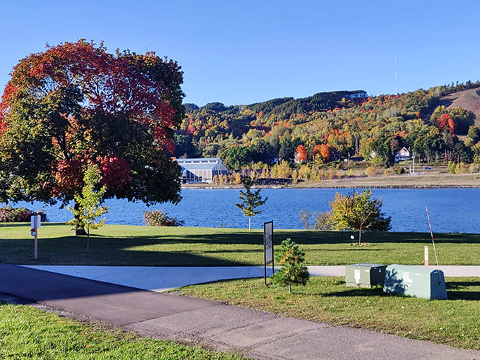 Fall foliage creates a natural frame for Portage Lake, where the boundary between reflection and reality blurs into watercolor perfection.
