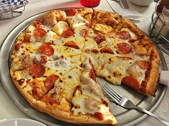 This isn't artisanal pizza with fancy ingredients – it's honest-to-goodness American pizza done right, with a perfect cheese pull guaranteed.