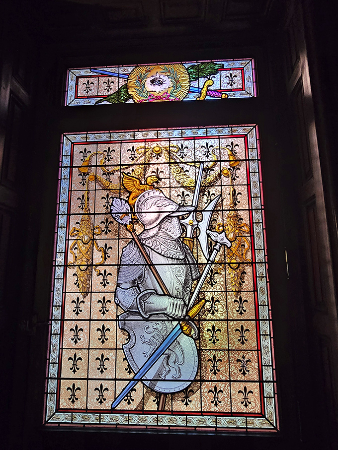 Medieval knights never looked this good in history books – this stained glass warrior stands eternal guard over the castle's interior, sword gleaming in perpetual readiness.