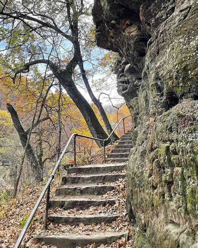 Stone steps carved into the hillside lead adventurers upward, each step revealing new perspectives of the gorge.