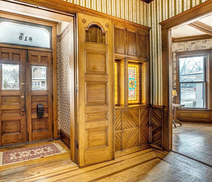 Wooden wainscoting and period-appropriate wallpaper create layers of texture that modern designers spend fortunes trying to replicate – authenticity you can touch.