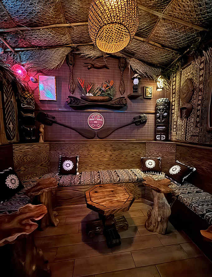 The immersive tiki environment at Lola's creates intimate dining nooks where bamboo, tropical artifacts, and ambient lighting transport you to Polynesia.