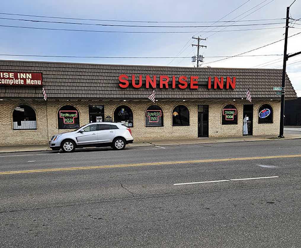 The iconic Sunrise Inn facade stands proudly on Warren's main street, its red lettering a beacon for hungry travelers seeking authentic Italian-American comfort food.