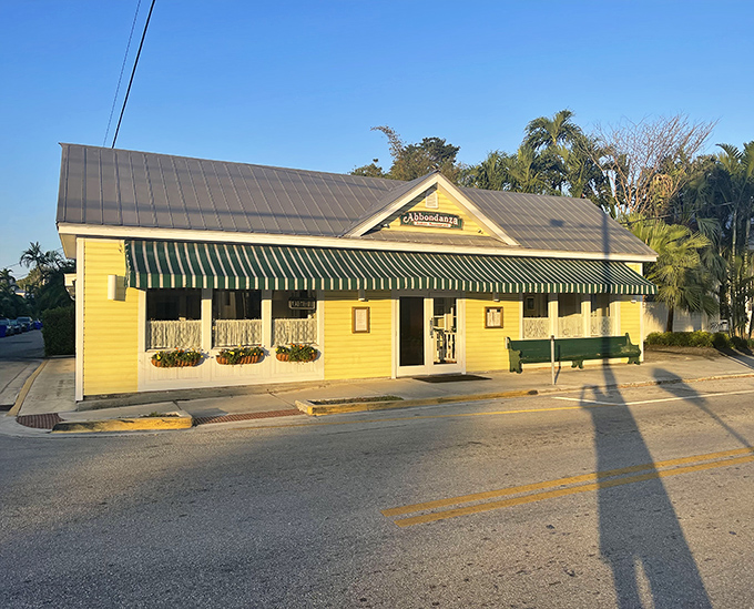 Abbondanza's cheerful yellow exterior stands like a beacon of culinary comfort on the Key West street corner, promising Italian delights within.