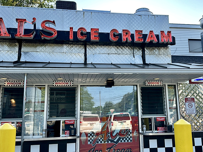 The iconic Al's Ice Cream sign glows with retro charm, promising sweet relief from Vermont summer days.