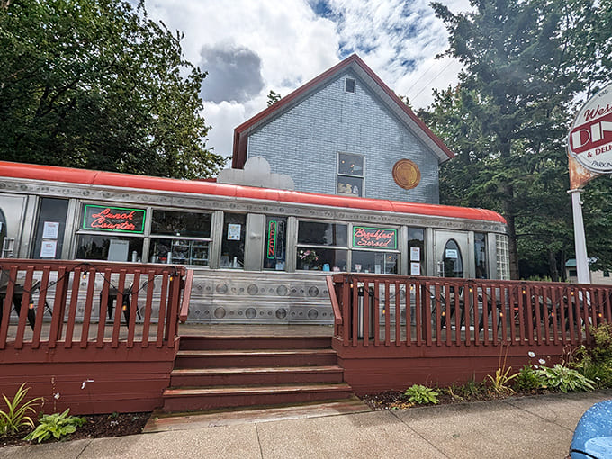 That red-trimmed exterior and welcoming deck whisper promises of comfort food and ice cream dreams waiting inside this Sandusky treasure.
