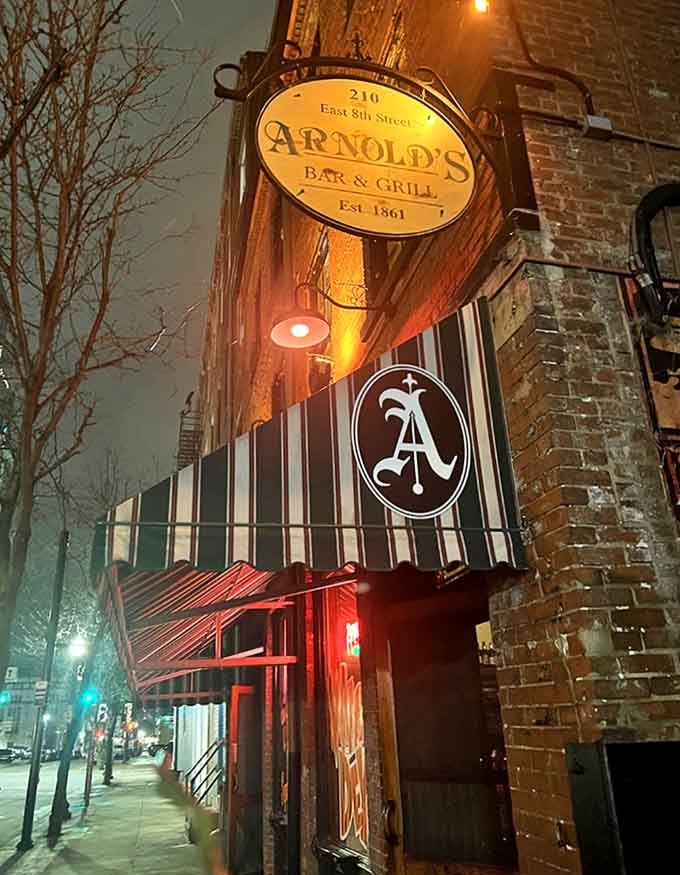 Arnold's iconic vintage sign glows like a beacon against the night sky, promising history and hospitality behind its brick facade.
