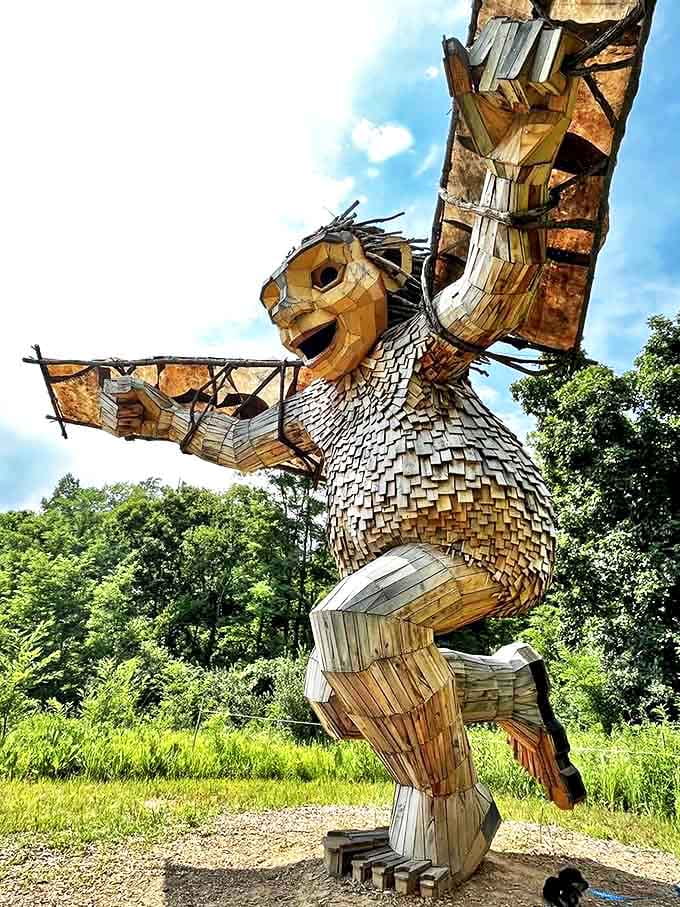 Aullwood's wooden guardian stands tall, a recycled masterpiece that transforms trash into treasure with mythological flair.