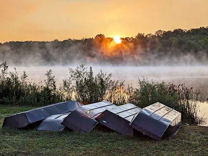 Morning mist hovers over Sunny Lake Park, creating a dreamlike scene where water meets sky in perfect harmony.