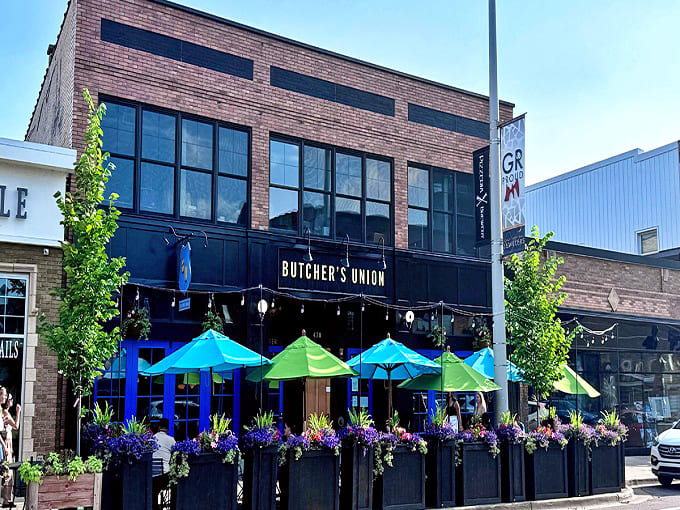 Welcome to Butcher&rsquo;s Union! Our vibrant patio and classic brick storefront are ready for a fantastic Grand Rapids afternoon out.