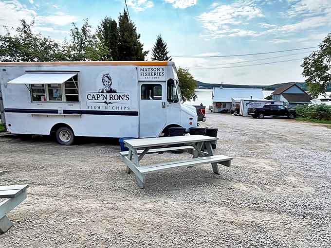 The iconic white Cap'n Ron's truck stands sentinel by Lake Superior, promising seafood treasures that would make Neptune himself swim ashore.