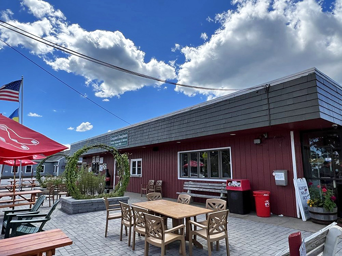 The charming red exterior of Congdon's Doughnuts stands ready to welcome hungry visitors with its no-frills charm and promise of sweet delights.