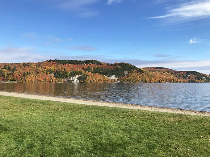 Nature's own masterpiece &ndash; fall foliage reflects perfectly in Crystal Lake's calm waters, creating a double feature of Vermont splendor.
