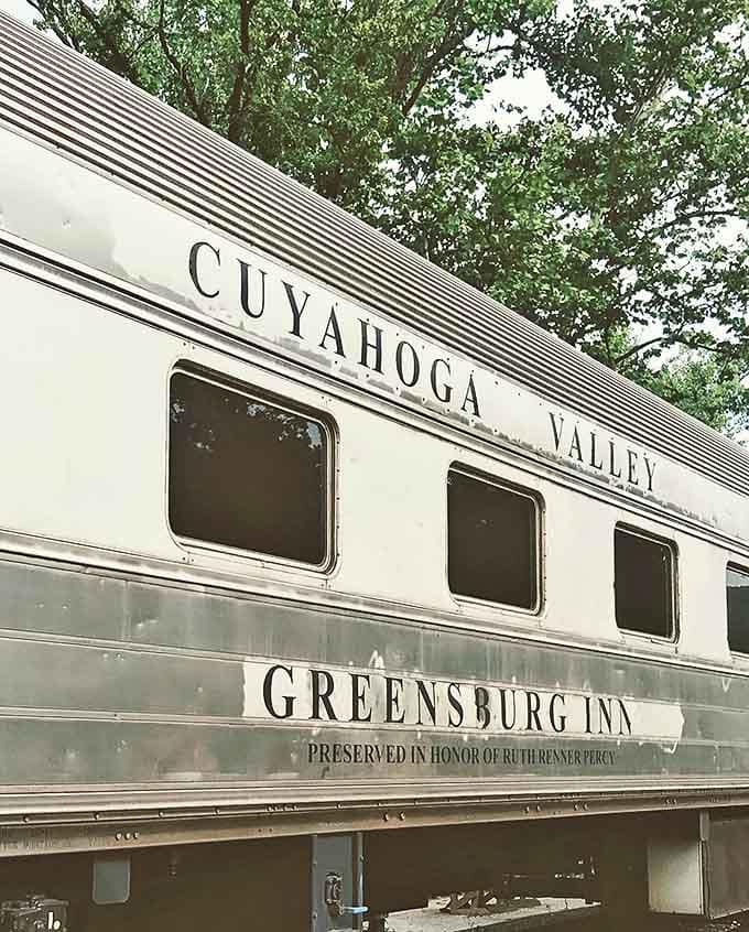 The historic Cuyahoga Valley "Greensburg Inn" car stands ready for adventure, its silver exterior gleaming with promises of scenic journeys ahead.