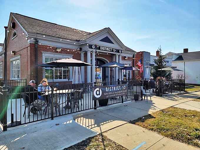 District 13's welcoming brick exterior invites you in with twinkling patio lights and classic columns &ndash; small-town charm with big-city sophistication.