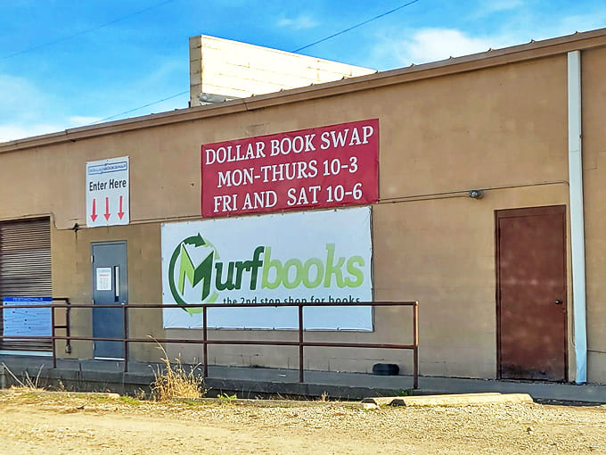 The unassuming exterior of Dollar Book Swap belies the literary wonderland within. Those red arrows know exactly what they're pointing to!