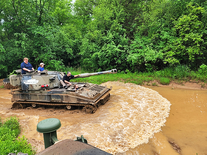 Mud, mayhem, and military might: A tank plows through muddy waters, proving that off-roading gets serious when treads replace tires.