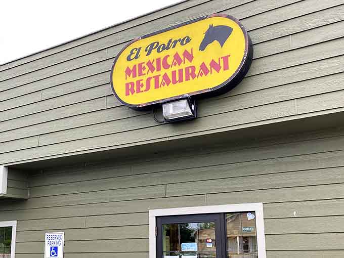 That cheerful yellow sign with the arrow might look modest, but it's pointing you toward some seriously good eating.