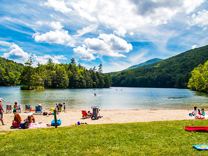 Emerald Lake State Park's beach area invites visitors to spread out and soak up Vermont sunshine while mountains stand guard in the distance.