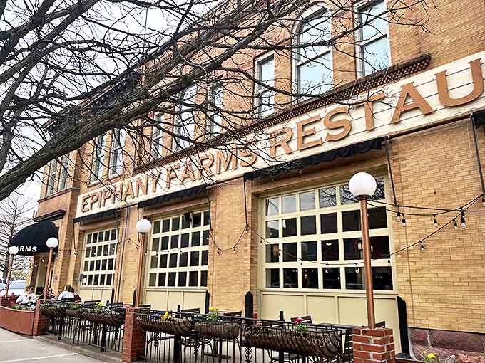 Epiphany Farms' welcoming brick fa&ccedil;ade invites passersby with promises of farm-fresh delights within. The outdoor seating area beckons on warm evenings.