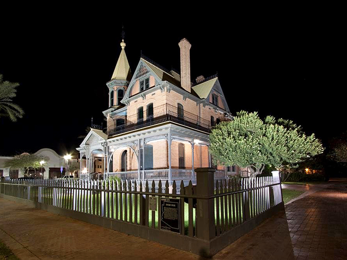 Step into a Victorian dream! The Rosson House glows like a ghostly apparition, its ornate details illuminated against the night sky.