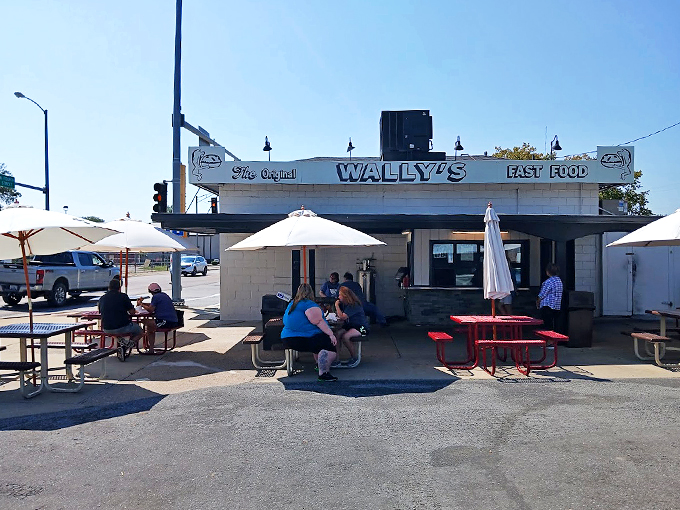 Welcome to burger paradise! Wally's Drive-In stands proud, its retro charm beckoning hungry travelers like a neon-lit lighthouse for empty stomachs.
