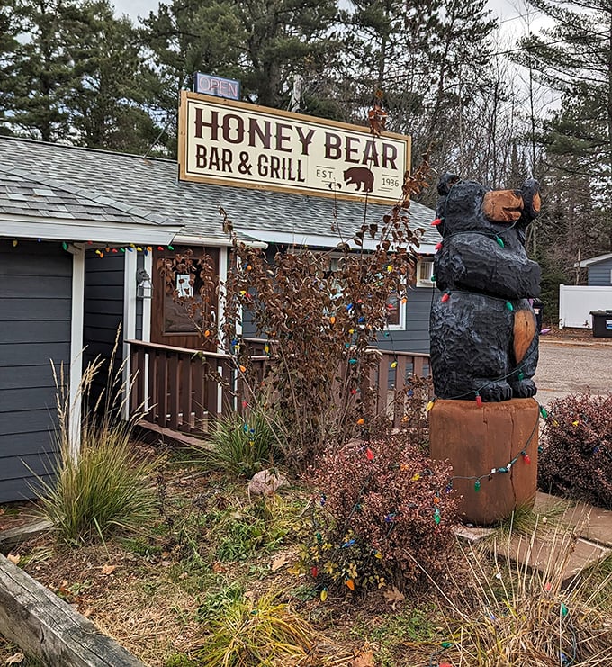 Welcome to cheese curd paradise! The Honey Bear's gray exterior and wooden mascot promise Northwoods magic inside.