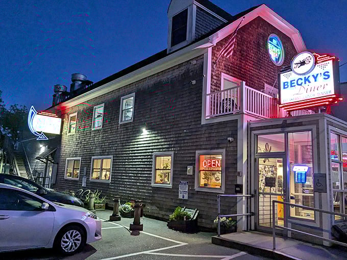 Becky's Diner glows like a beacon against the twilight sky, its weathered shingles and neon sign promising seafood salvation to hungry travelers.