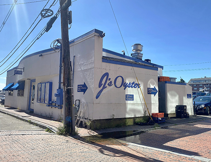 J's Oyster stands proudly on Portland Pier, its unassuming white exterior with blue trim hiding seafood treasures that locals have treasured for generations.