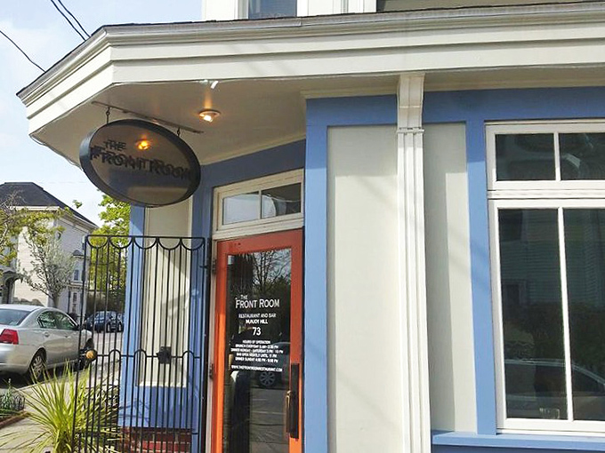 The charming blue exterior of The Front Room beckons hungry diners with its unassuming elegance and neighborhood vibe.