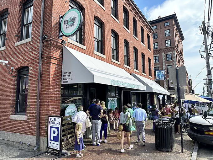 The Holy Donut's brick exterior beckons hungry visitors with its mint-green sign, while a line of eager donut enthusiasts forms outside &ndash; Portland's worst-kept delicious secret.