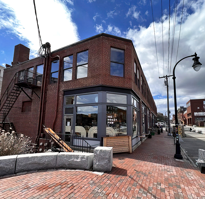 The Honey Paw's brick corner building stands confidently on Portland's Middle Street, its large windows offering a glimpse of the culinary magic happening inside.