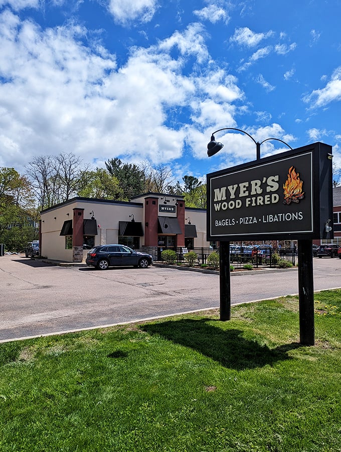 Myer's Wood Fired stands proudly against Vermont's blue sky, its sign promising the holy trinity of comfort food: bagels, pizza, and libations.