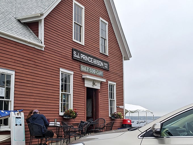 The iconic red clapboard building of Salt Cod Cafe stands proudly against the Maine sky, a beacon of breakfast perfection on Orr's Island.