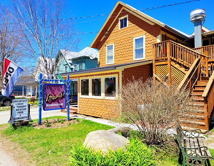 Bernie's welcoming exterior beckons with its honey-colored siding and vibrant signage, promising comfort food treasures within this Montgomery Center gem.