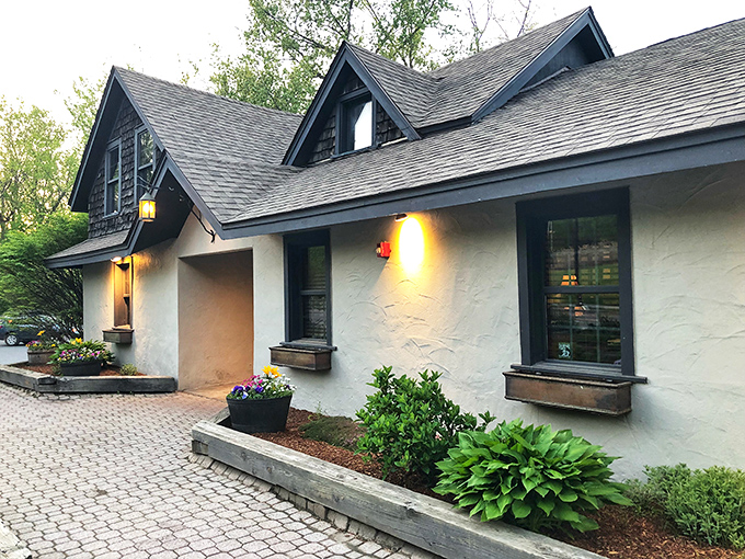 Charming storybook cottage vibes welcome hungry visitors to this barbecue haven, where smoke signals promise delicious things ahead.