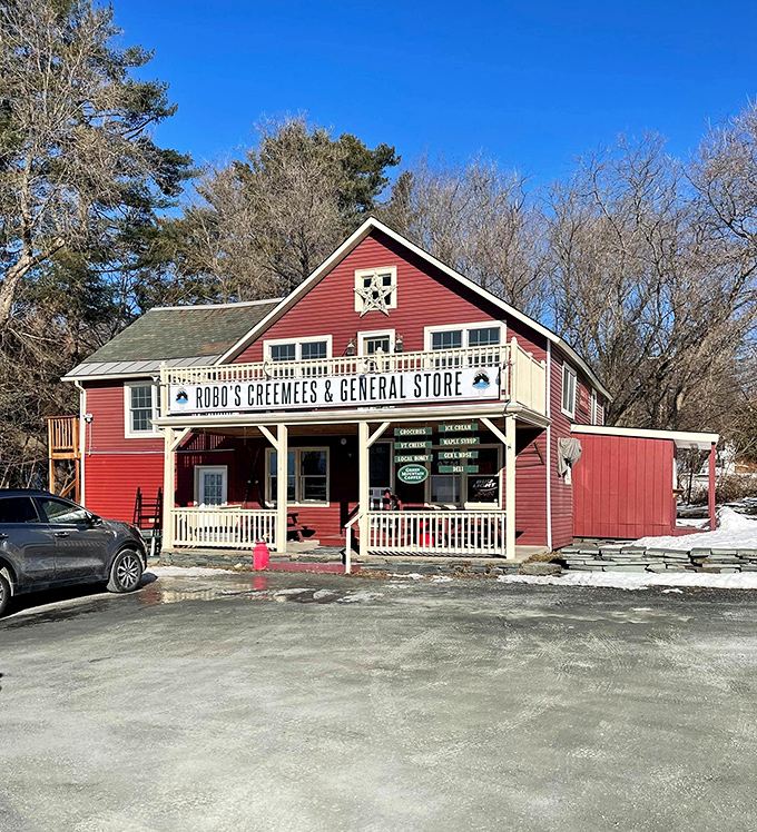 The iconic red clapboard exterior of Robo's Creemees & General Store stands proudly against Vermont's blue sky, a beacon of deliciousness at Lake Bomoseen.