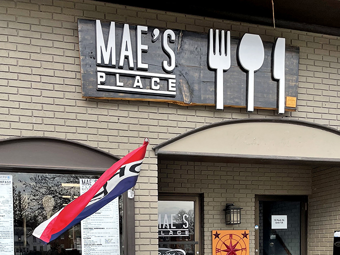 The iconic Mae's Place storefront beckons hungry travelers with its charming brick exterior and playful utensil signage – a beacon of breakfast bliss in Brandon.