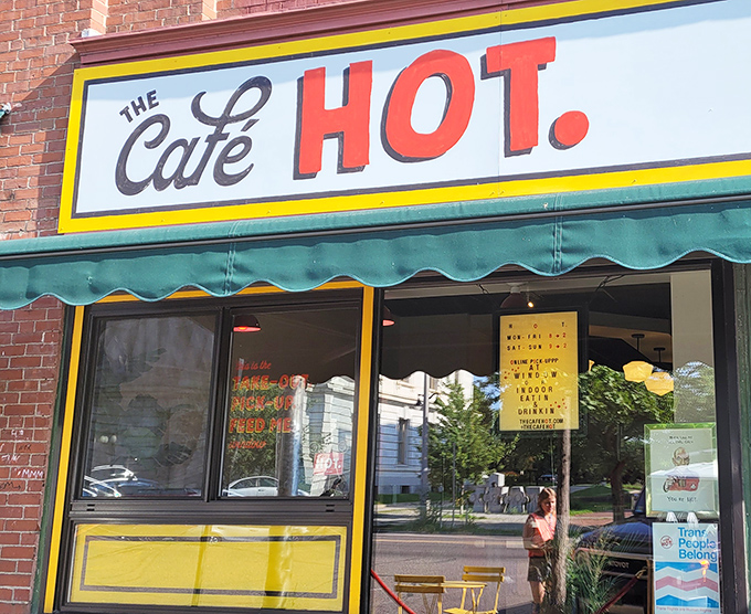 The iconic yellow-trimmed storefront of The Caf&eacute; HOT. beckons hungry visitors with its simple yet inviting fa&ccedil;ade, promising delicious treasures within.