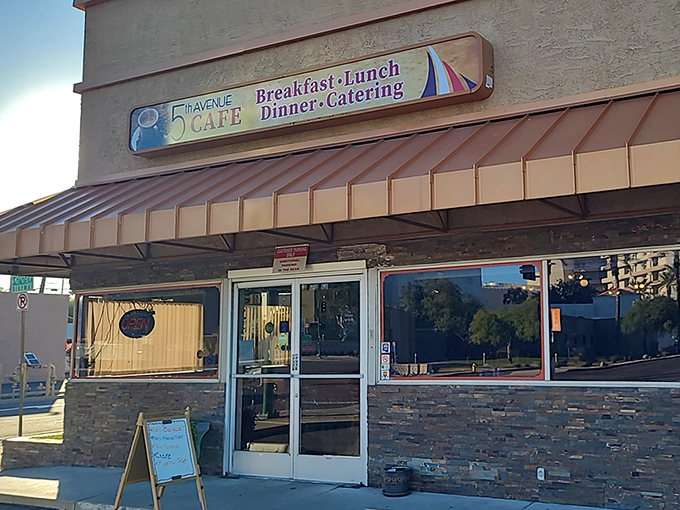 Exterior: The welcoming stone facade and copper awning of 5th Avenue Cafe stands ready to transform your morning from ordinary to extraordinary.