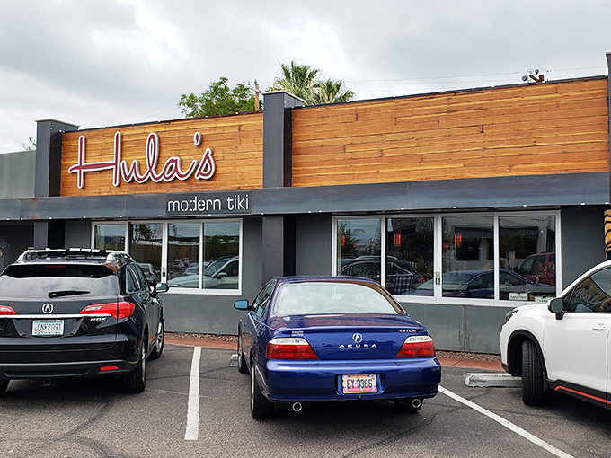 Hula's Modern Tiki welcomes desert dwellers with its distinctive wooden fa&ccedil;ade and neon signage &ndash; a tropical beacon in Phoenix's urban landscape.