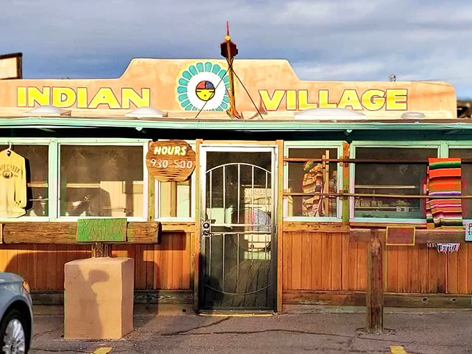The sun-baked facade of Indian Village beckons with its vibrant yellow sign and turquoise accents &ndash; a desert oasis of flavor hiding in plain sight.