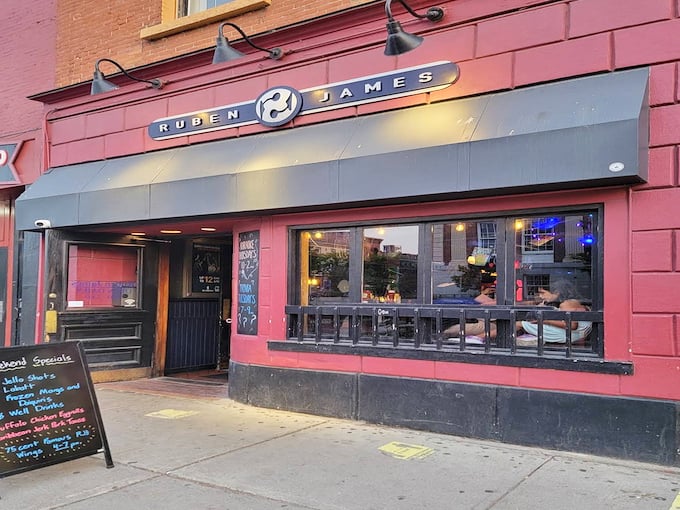 Exterior: The crimson facade of Ruben James beckons like an old friend, promising good times behind that unassuming storefront.